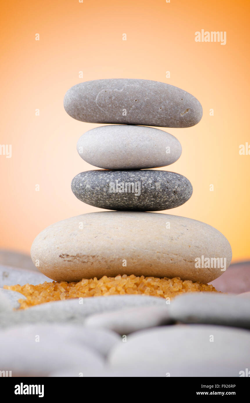 Balanced pebbles with colour background Stock Photo - Alamy