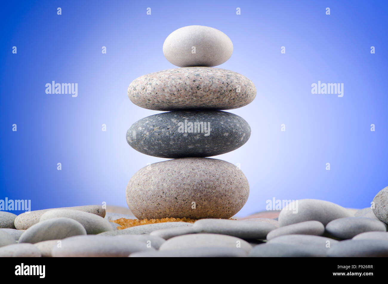 Balanced pebbles with colour background Stock Photo - Alamy