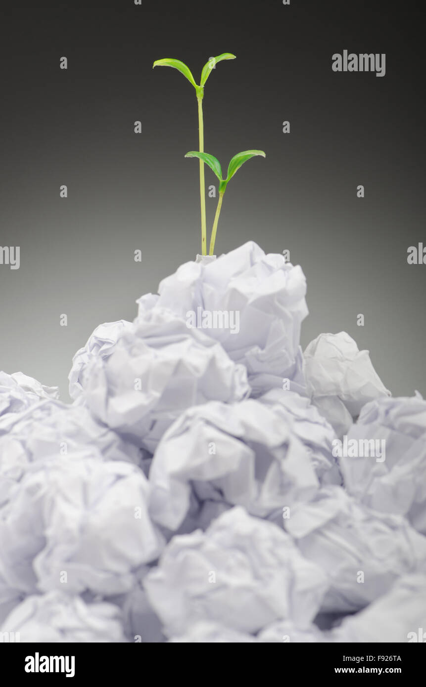 Green seedlings growing out of paper Stock Photo - Alamy