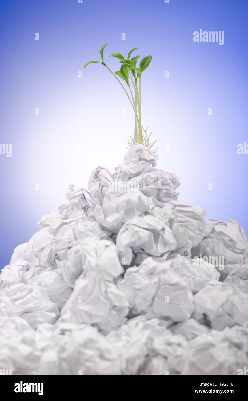 Green seedlings growing out of paper Stock Photo - Alamy