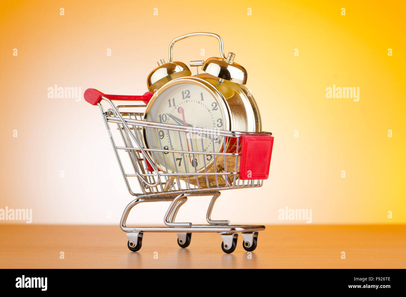 Buying time concept with clock and shopping cart Stock Photo - Alamy