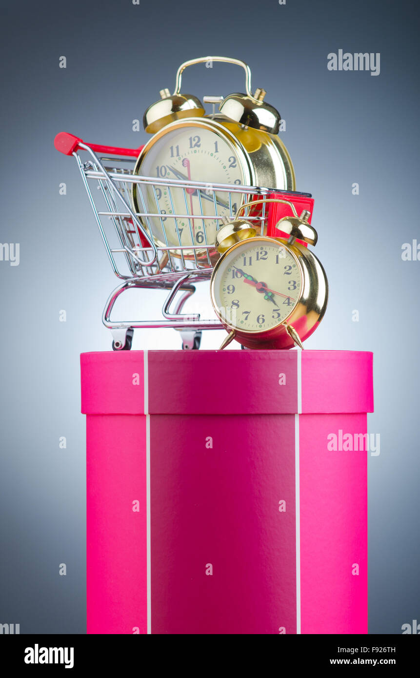 Buying time concept with clock and shopping cart Stock Photo - Alamy