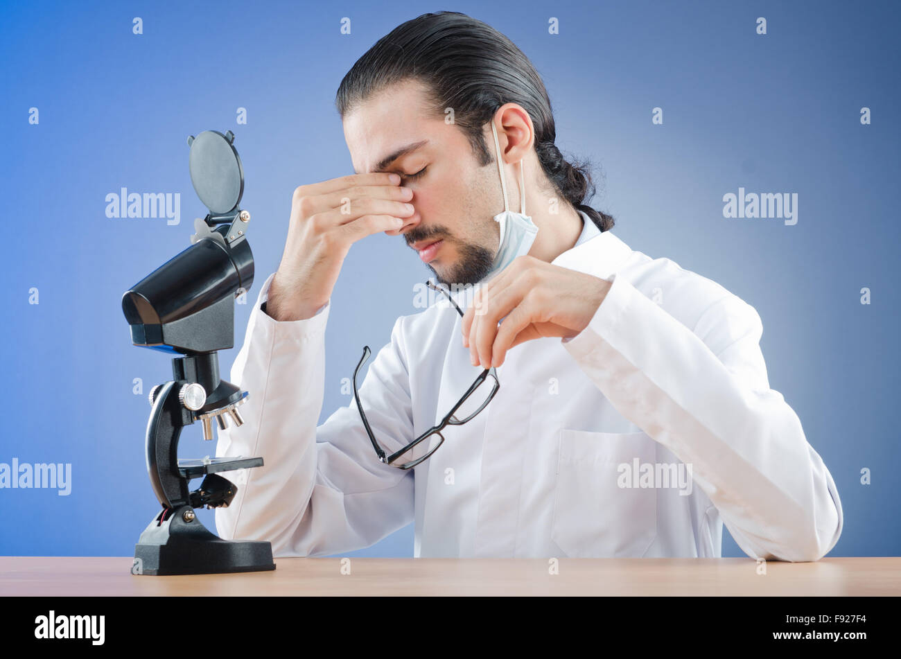 Chemist working with microscope Stock Photo - Alamy