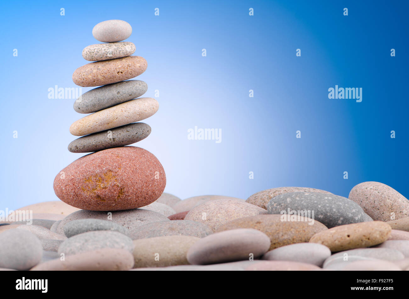 Pebbles stack against gradient background Stock Photo - Alamy
