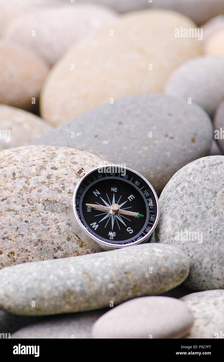 Navigation compass on stone pebbles Stock Photo - Alamy