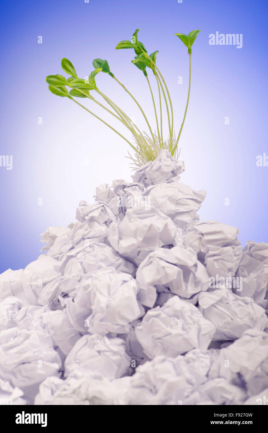 Green seedlings growing out of paper Stock Photo - Alamy