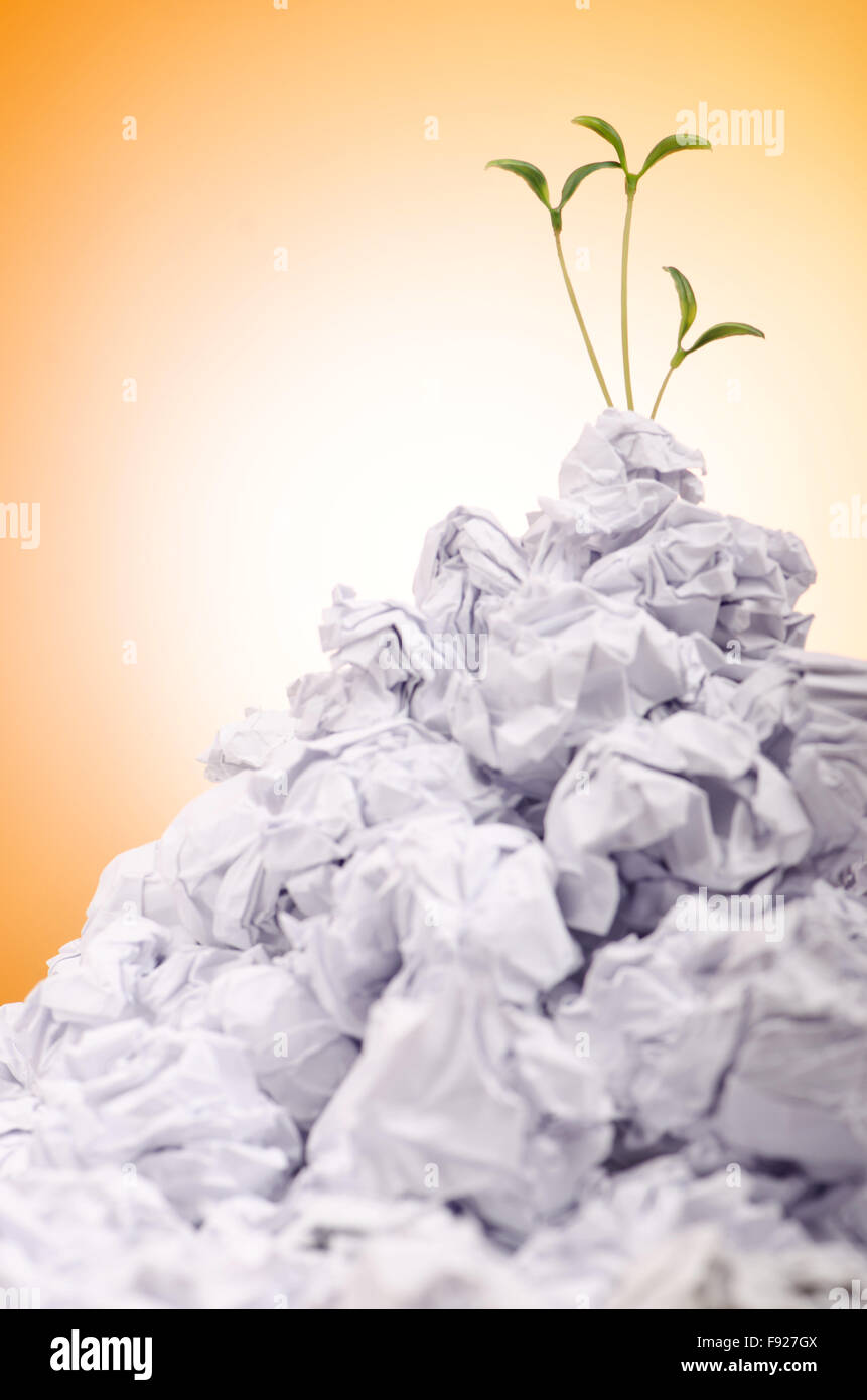 Green seedlings growing out of paper Stock Photo - Alamy