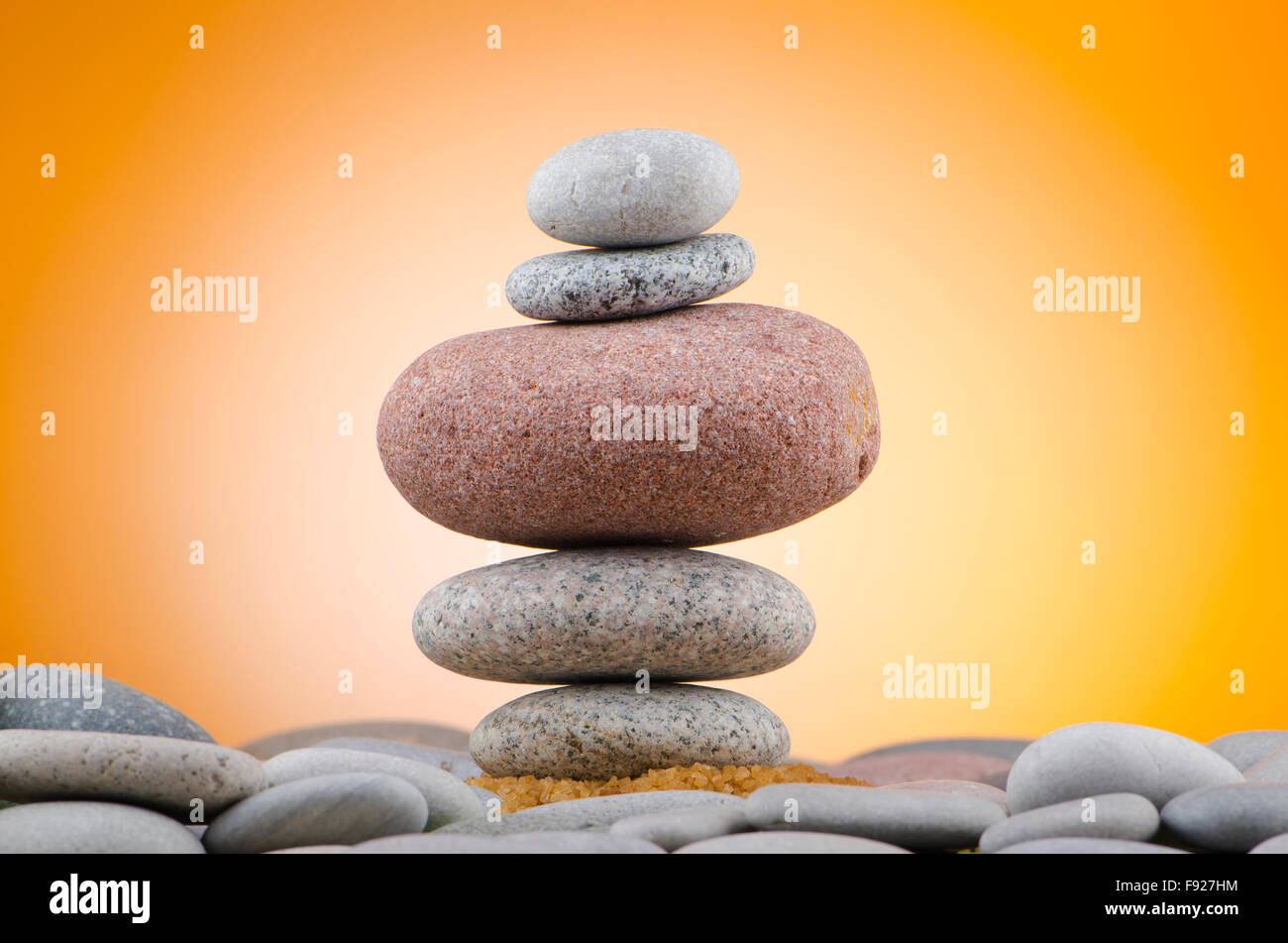 Balanced pebbles with colour background Stock Photo - Alamy
