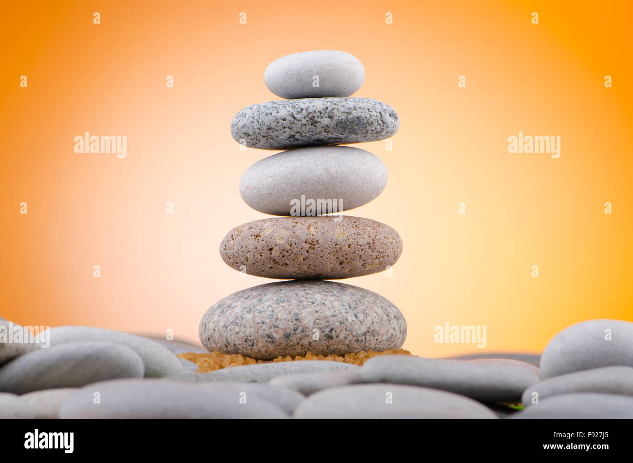 Balanced pebbles with colour background Stock Photo - Alamy