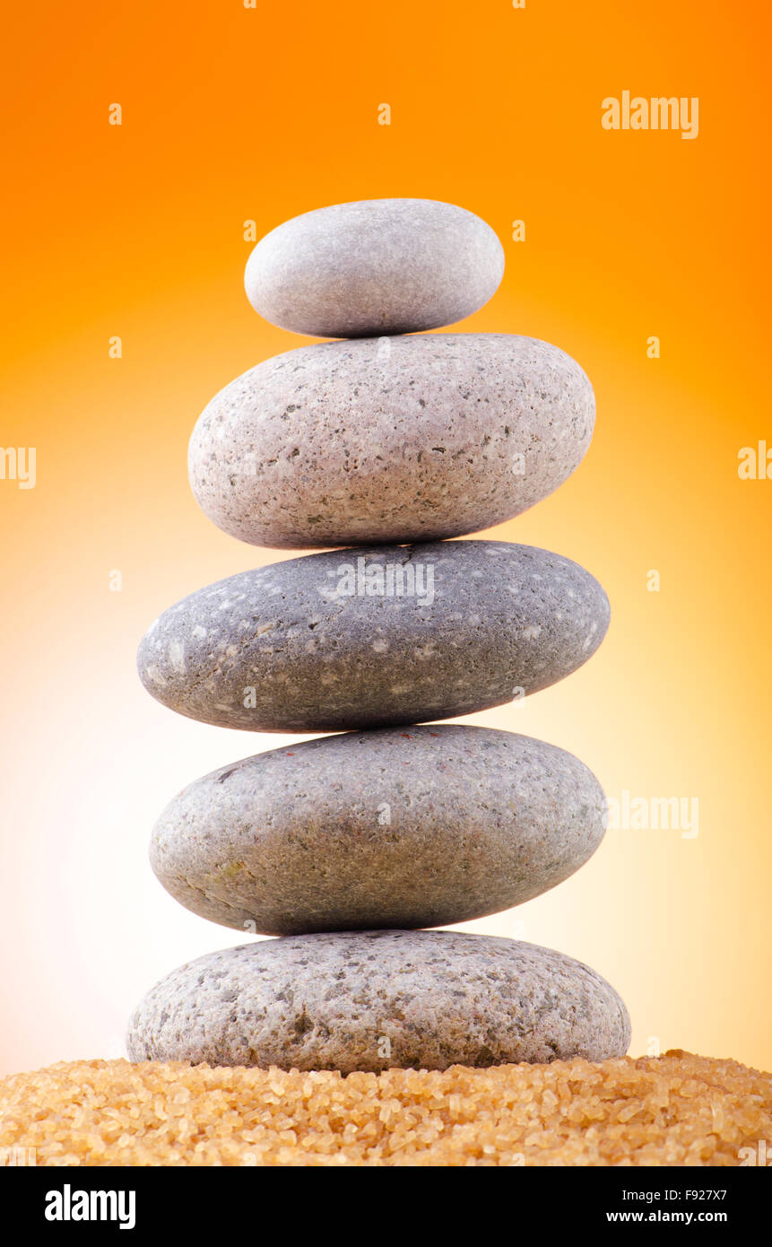 Balanced pebbles with colour background Stock Photo - Alamy