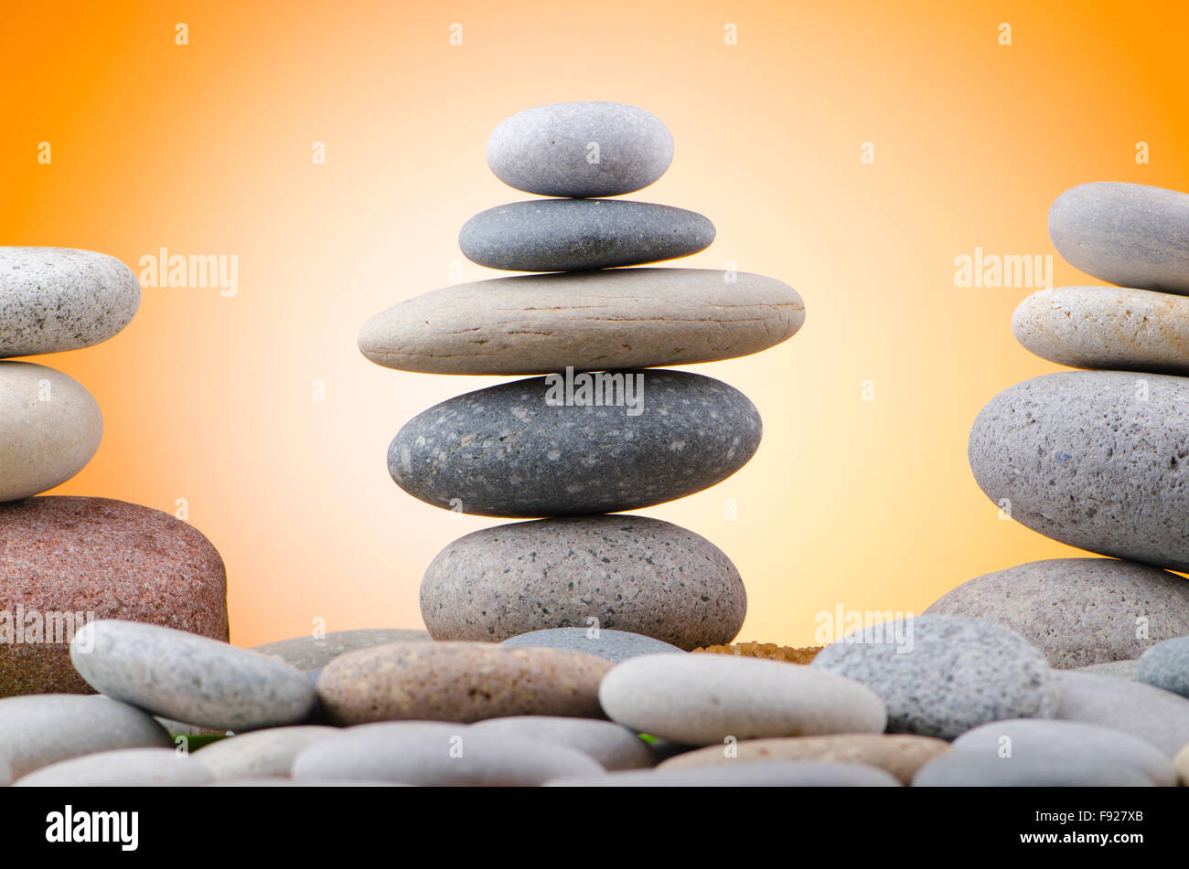 Balanced pebbles with colour background Stock Photo - Alamy