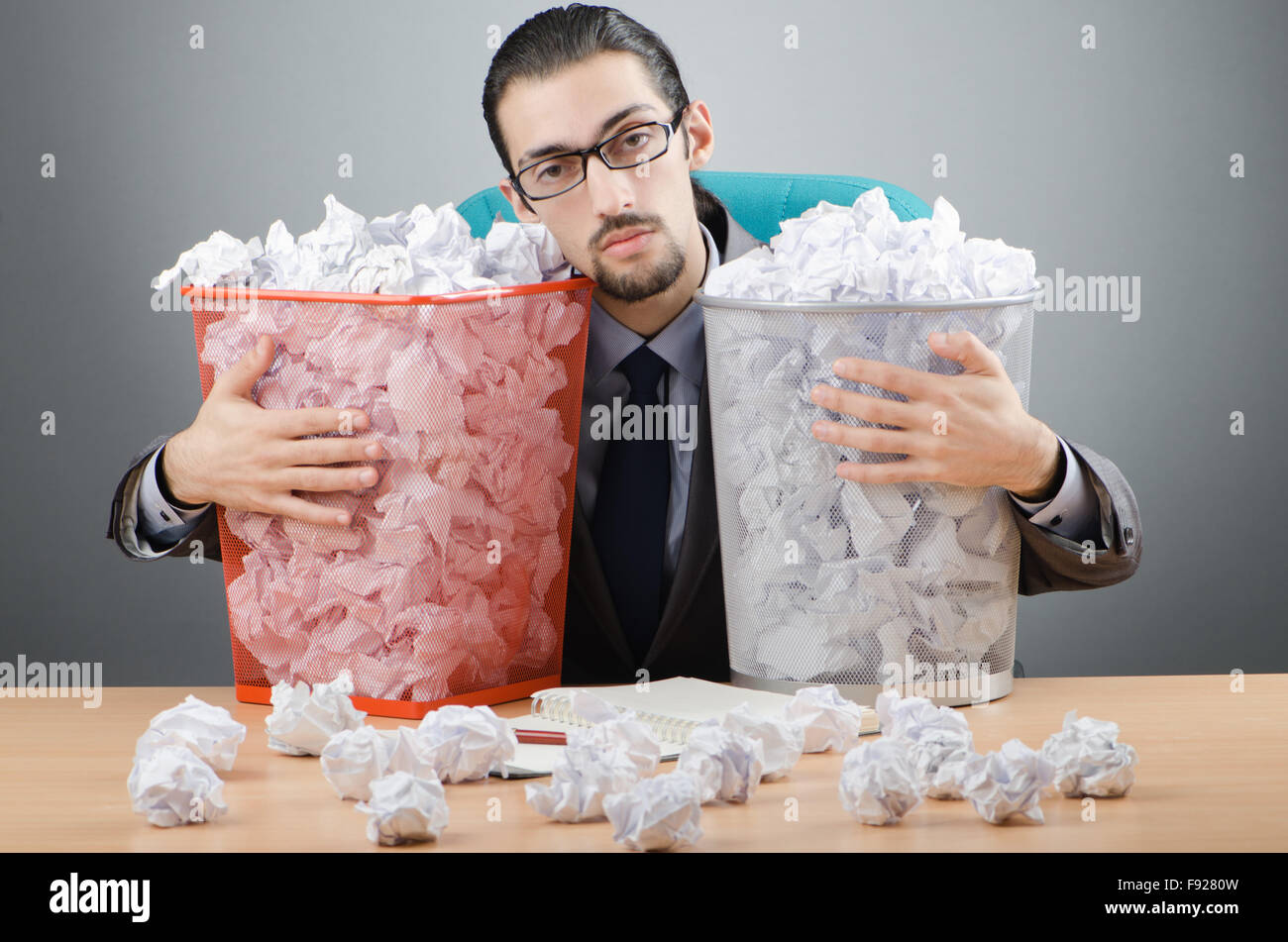 Man with lots of wasted paper Stock Photo - Alamy