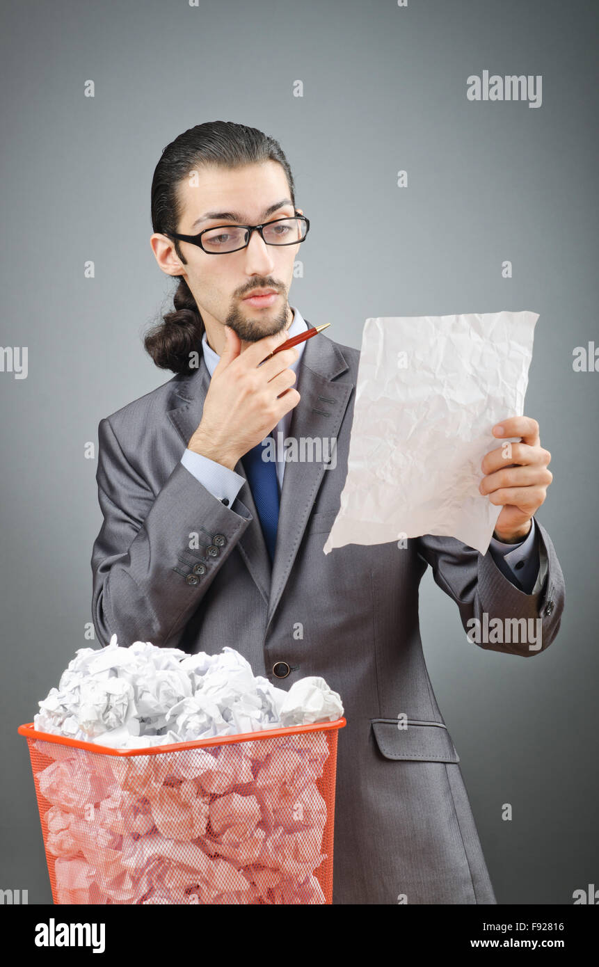 Man with lots of wasted paper Stock Photo - Alamy