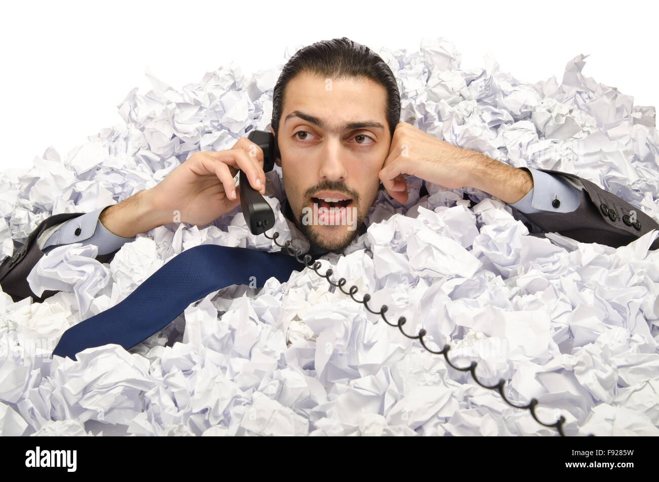 Man with lots of crumpled paper Stock Photo - Alamy