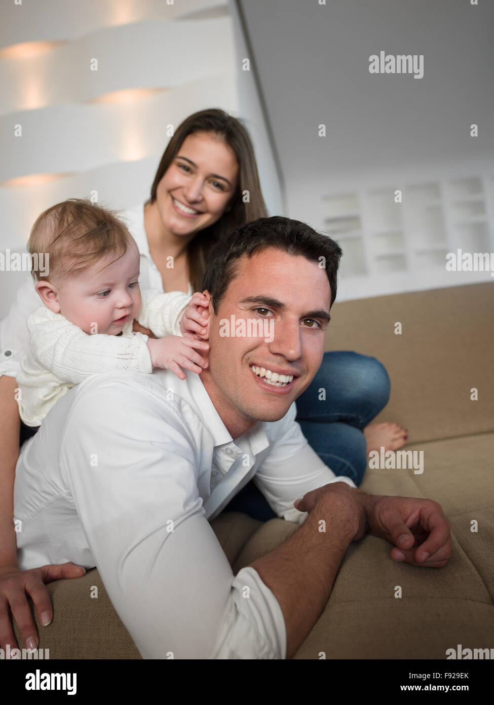 happy young family couple with beautiful new born baby have fun at ...