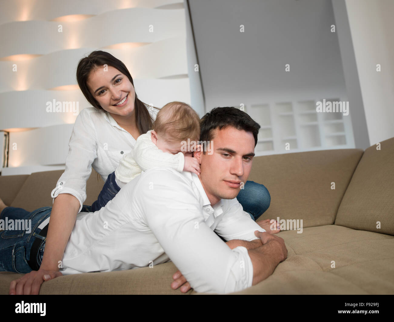 happy young family couple with beautiful new born baby have fun at ...