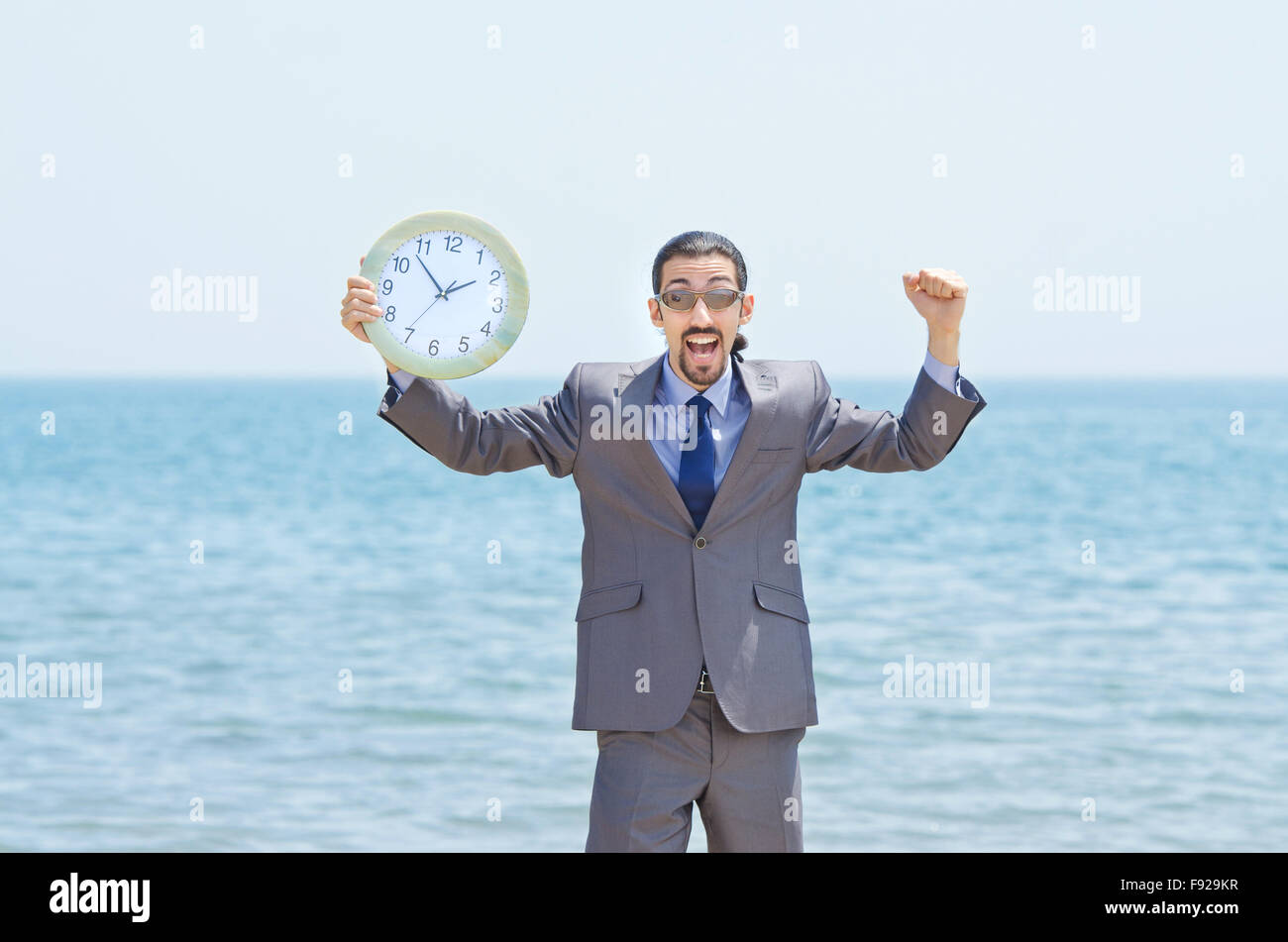 Man with clock on seaside Stock Photo - Alamy