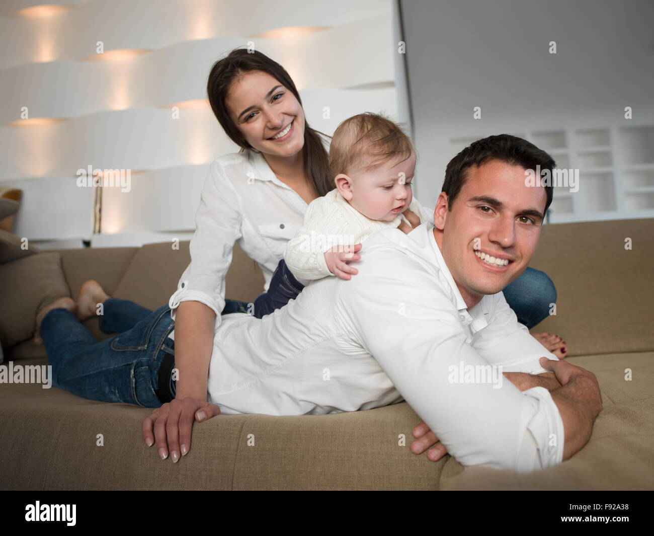 happy young family couple with beautiful new born baby have fun at ...