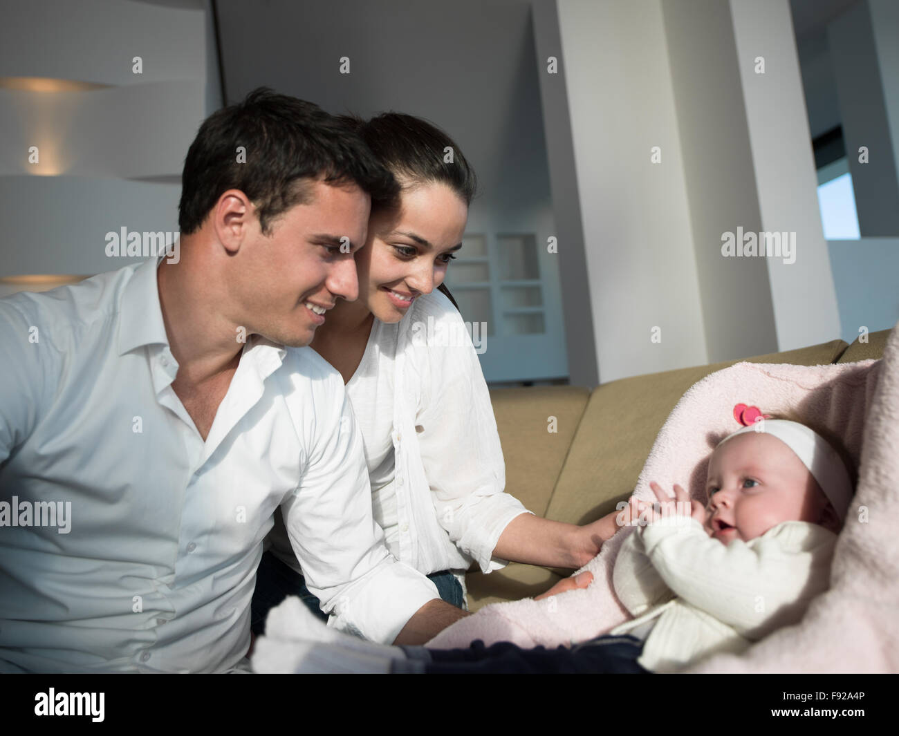 happy young family couple with beautiful new born baby have fun at ...