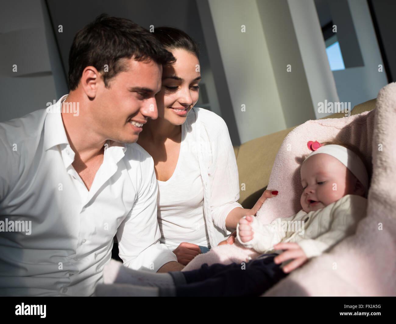 happy young family couple with beautiful new born baby have fun at ...