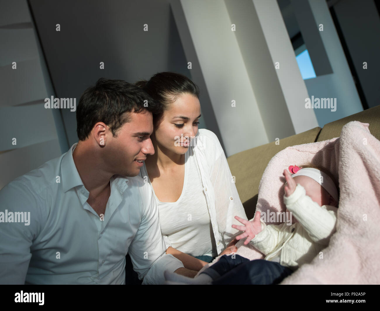 happy young family couple with beautiful new born baby have fun at ...