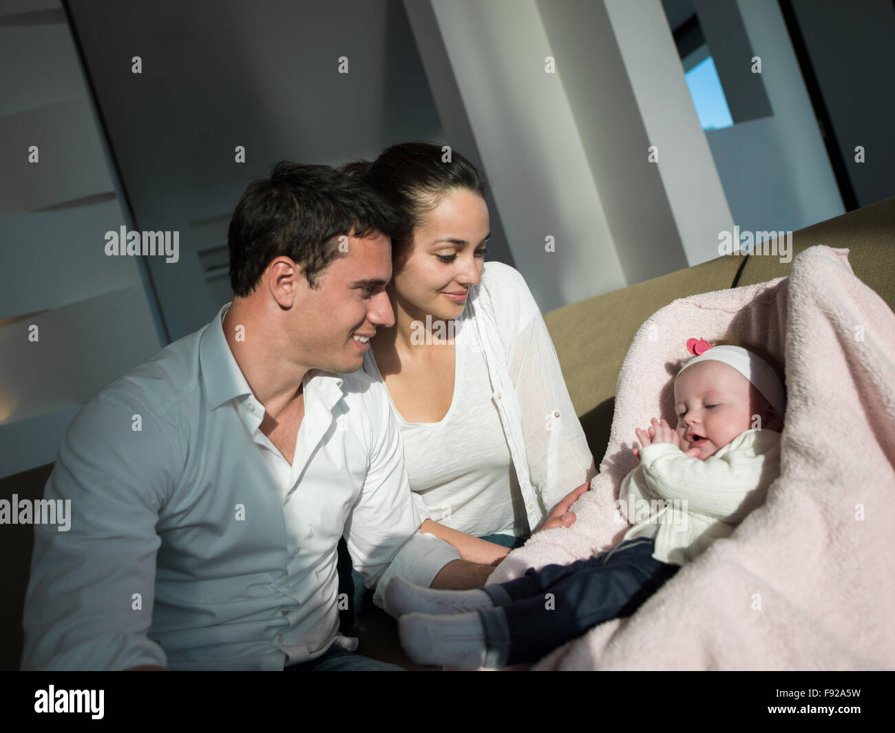 happy young family couple with beautiful new born baby have fun at ...