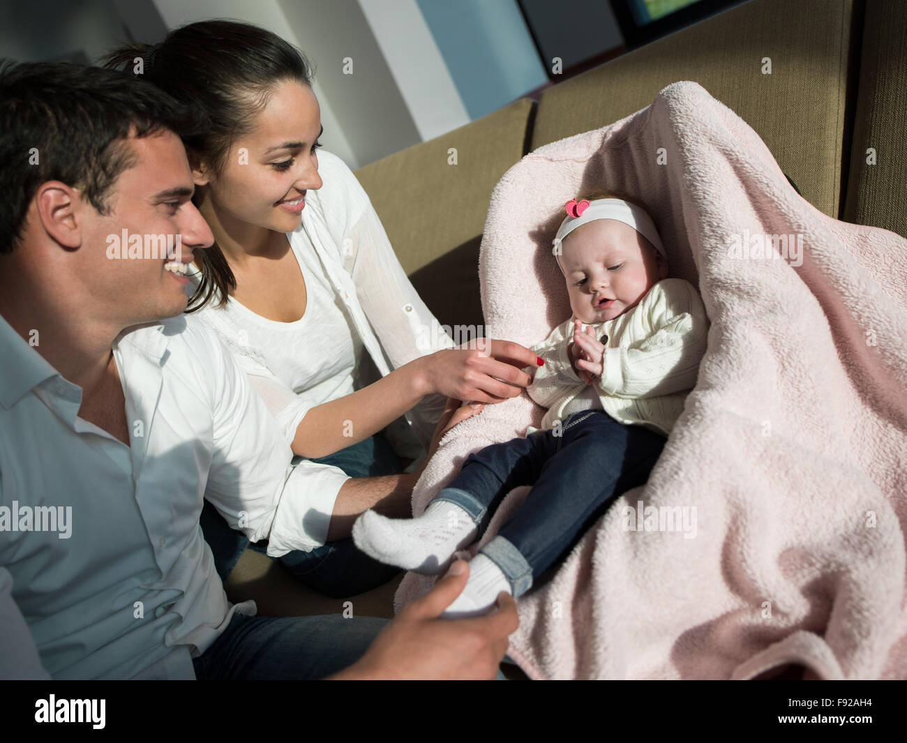 happy young family couple with beautiful new born baby have fun at ...