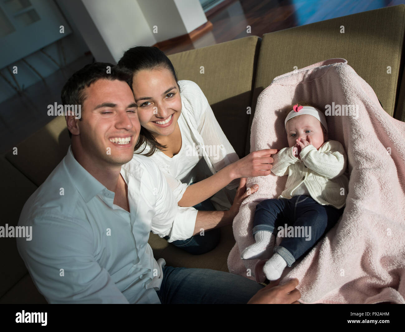 happy young family couple with beautiful new born baby have fun at ...
