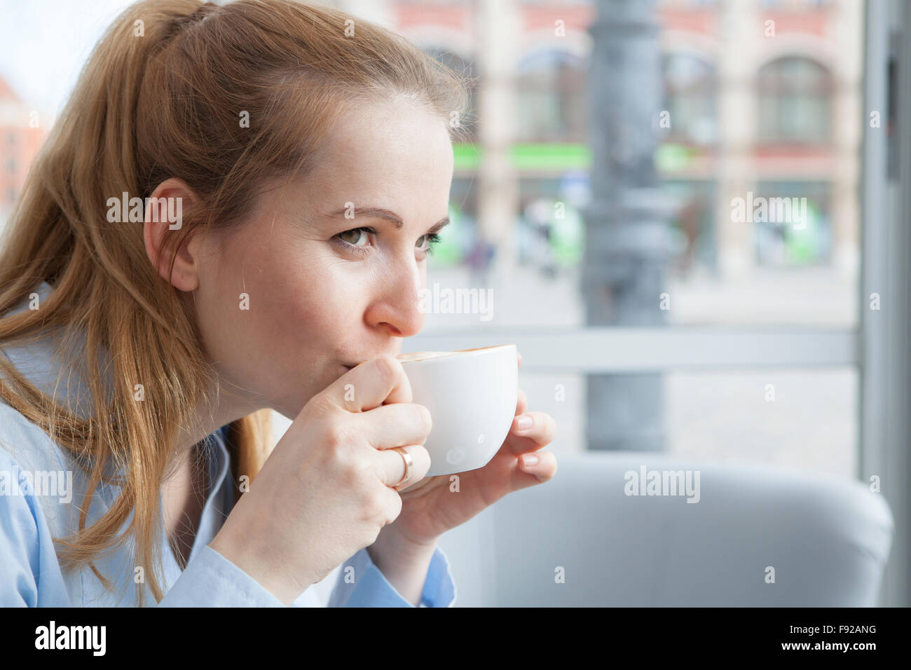 Woman drinking coffee Stock Photo - Alamy