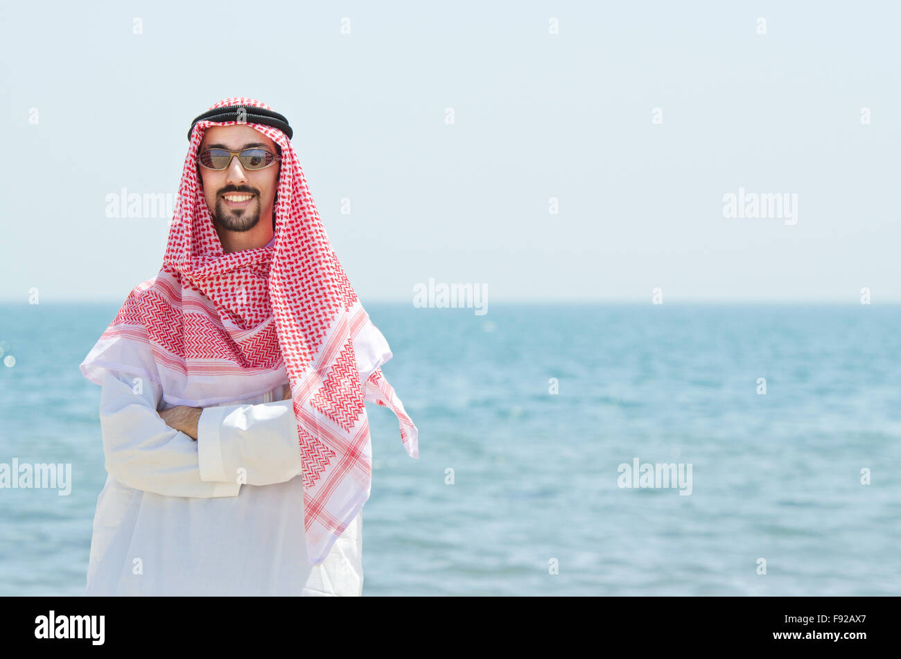 Arab on seaside in traditional clothing Stock Photo - Alamy
