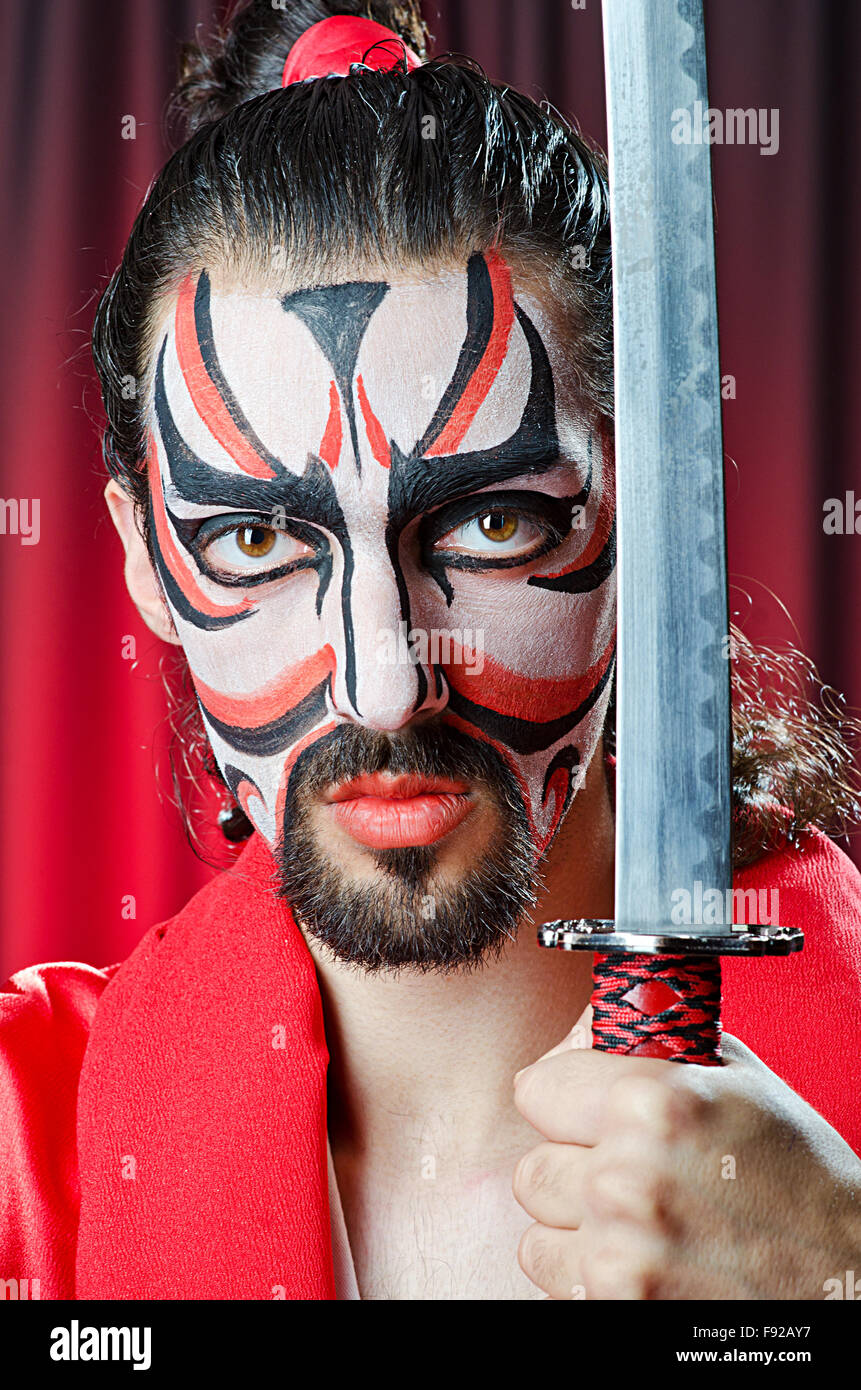 Man with face mask and sword Stock Photo - Alamy