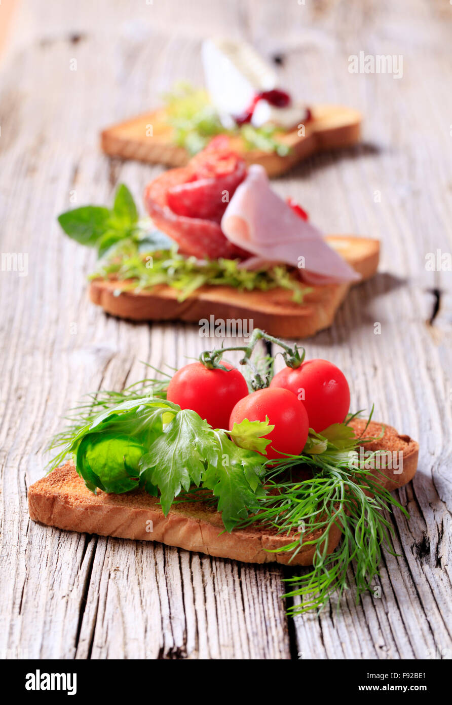 Three pieces of toast with various toppings Stock Photo - Alamy