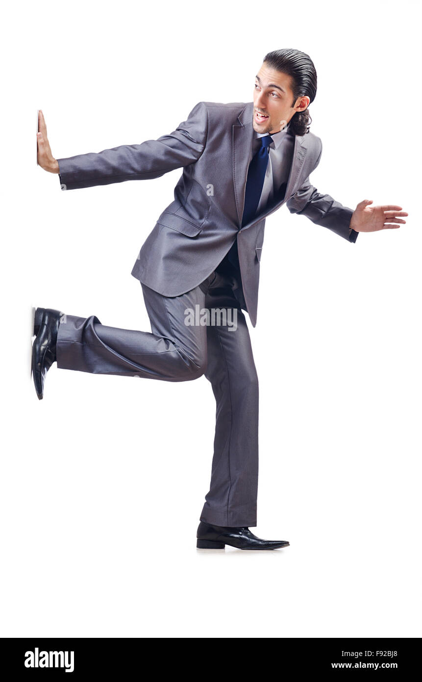Young businessman pushing invisible obstacles Stock Photo - Alamy