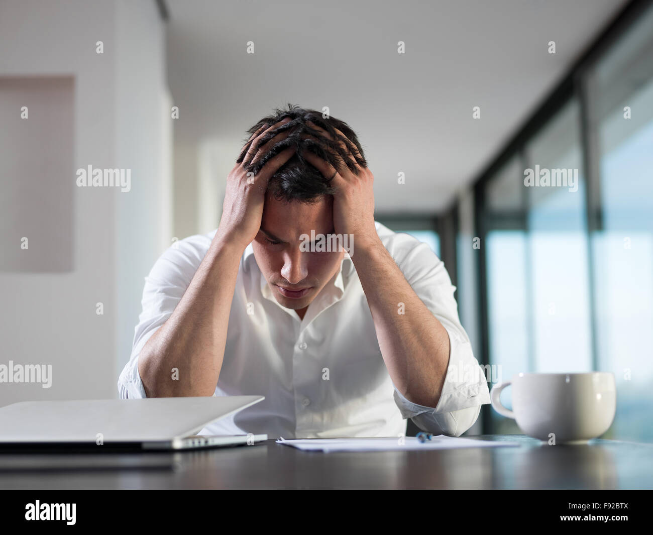 frustrated with problems young business man working on laptop computer ...
