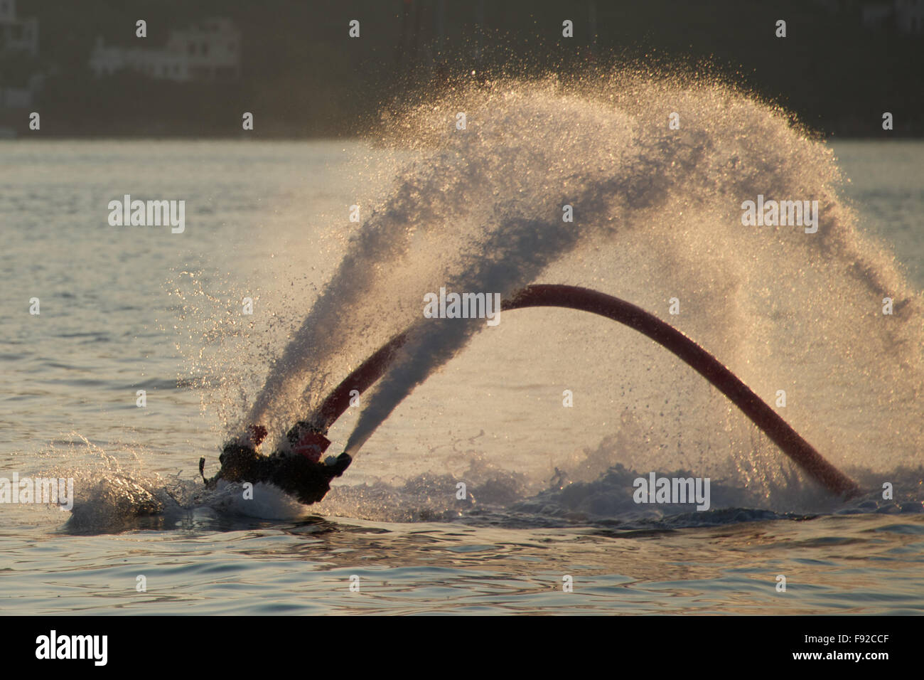 Flyboarder only showing feet after semi-circular dive Stock Photo - Alamy