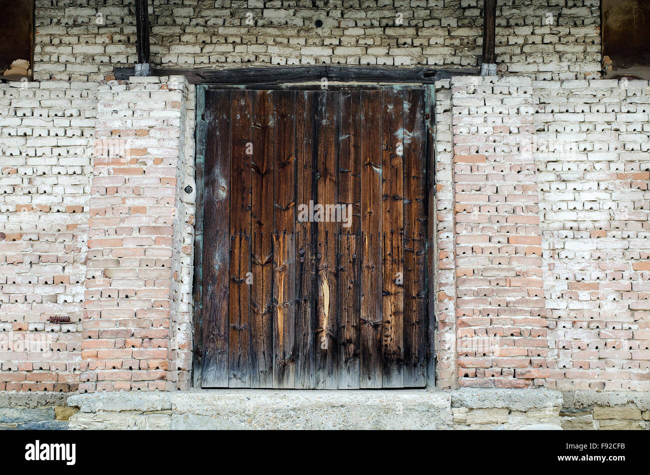 Old wooden gate at brick building Stock Photo - Alamy