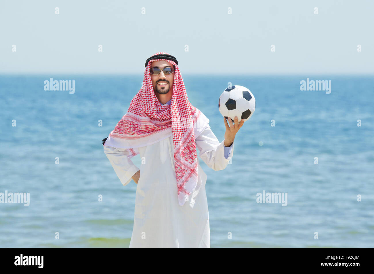 Arab with footbal at seaside Stock Photo - Alamy