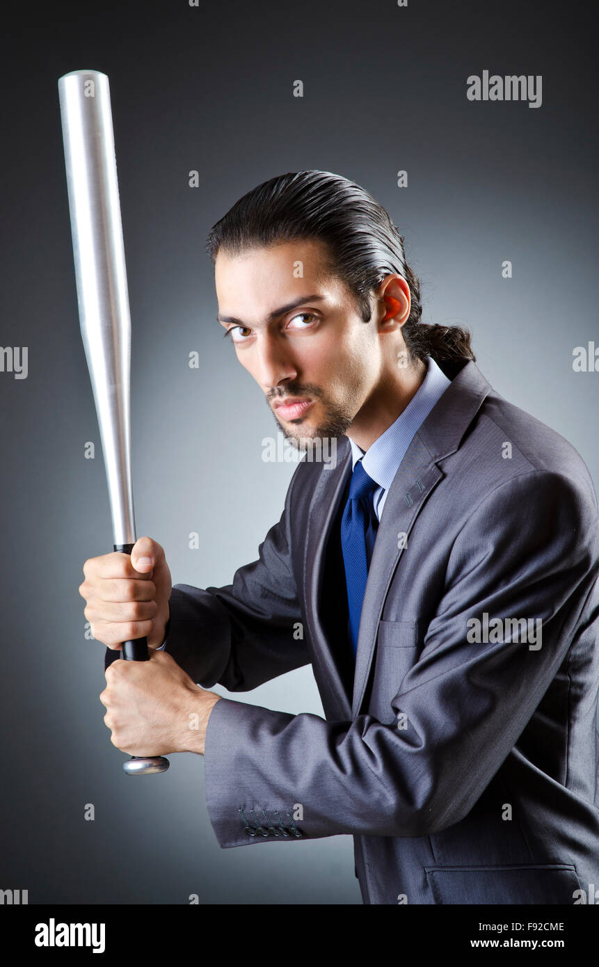 Angry businessman with bat on white Stock Photo - Alamy