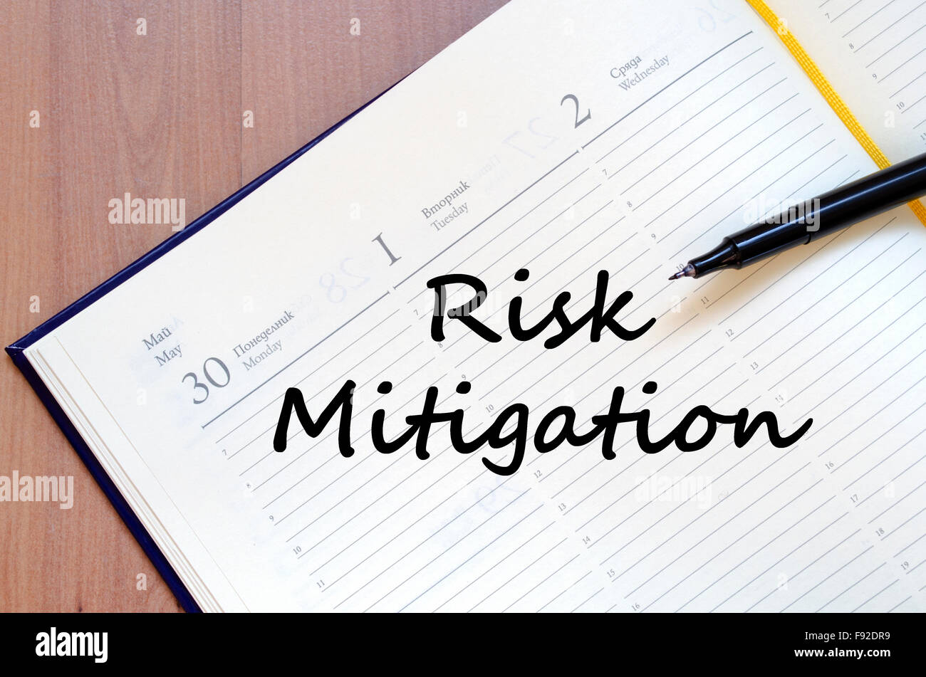 Risk mitigation text concept write on notebook with pen Stock Photo - Alamy