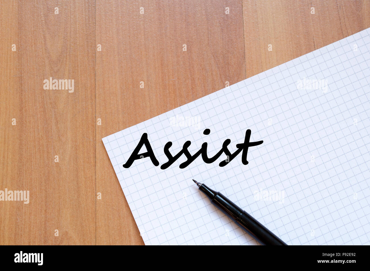 Assist text concept write on notebook with pen Stock Photo - Alamy