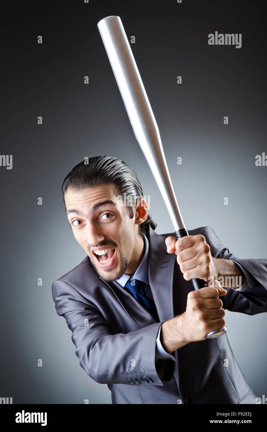 Angry businessman with bat on white Stock Photo - Alamy