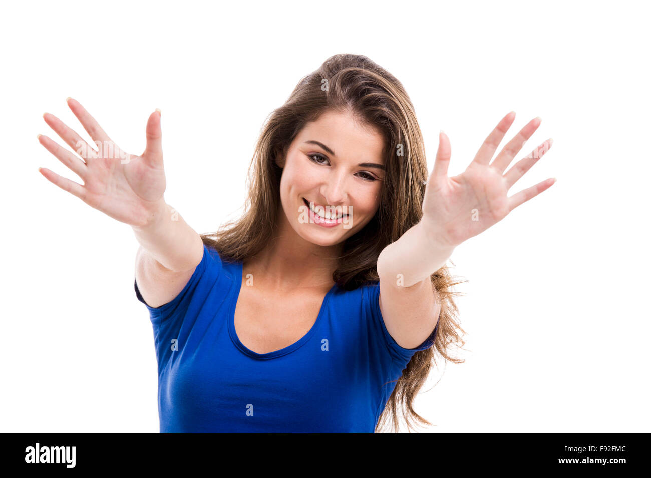 Beautiful young woman standing with her arms open, isolated over a ...