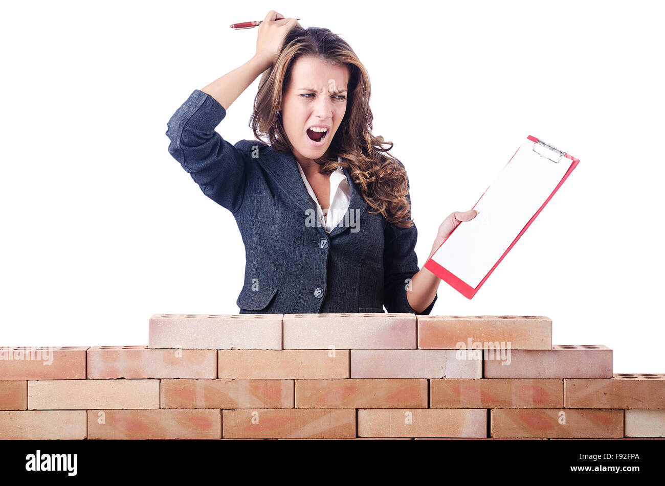 Woman builder and brick wall Stock Photo - Alamy