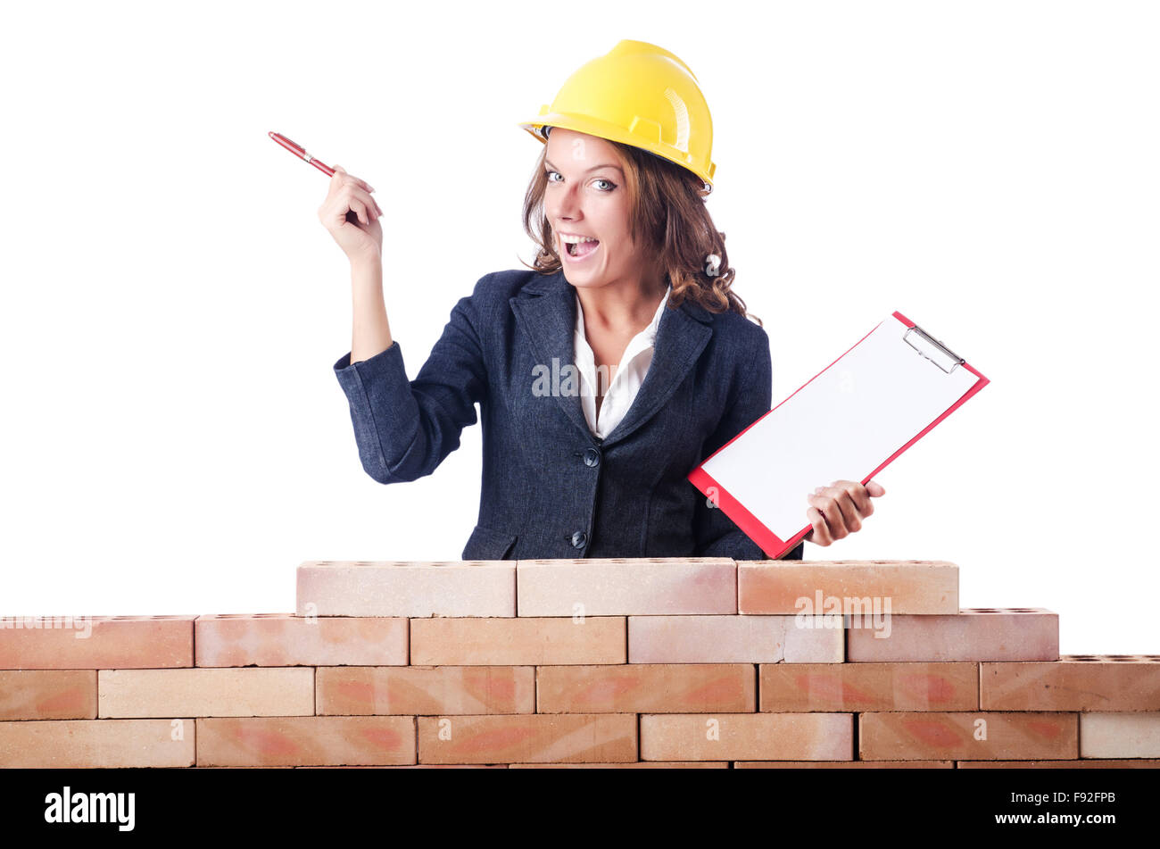 Woman builder and brick wall Stock Photo - Alamy