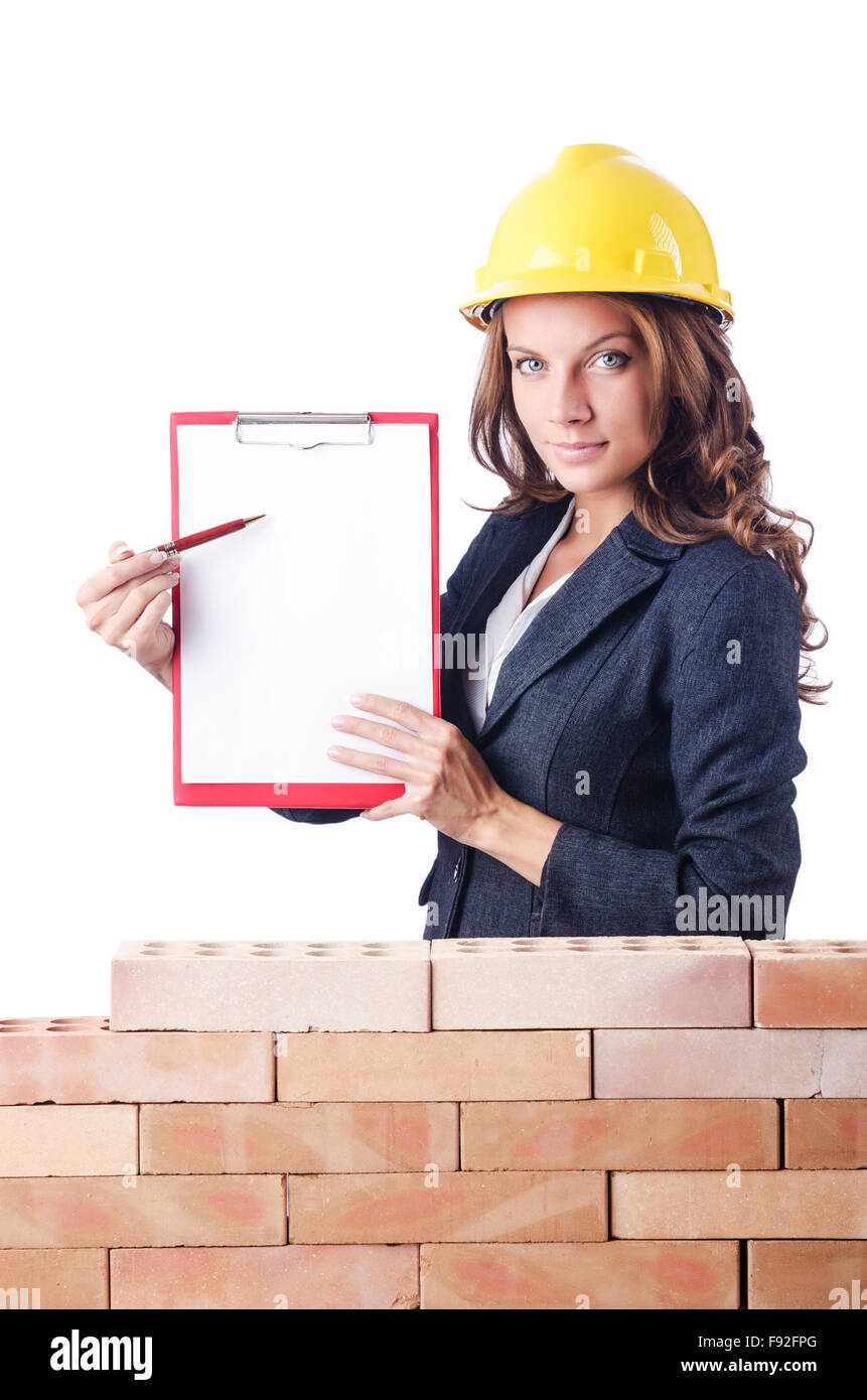 Woman builder and brick wall Stock Photo - Alamy