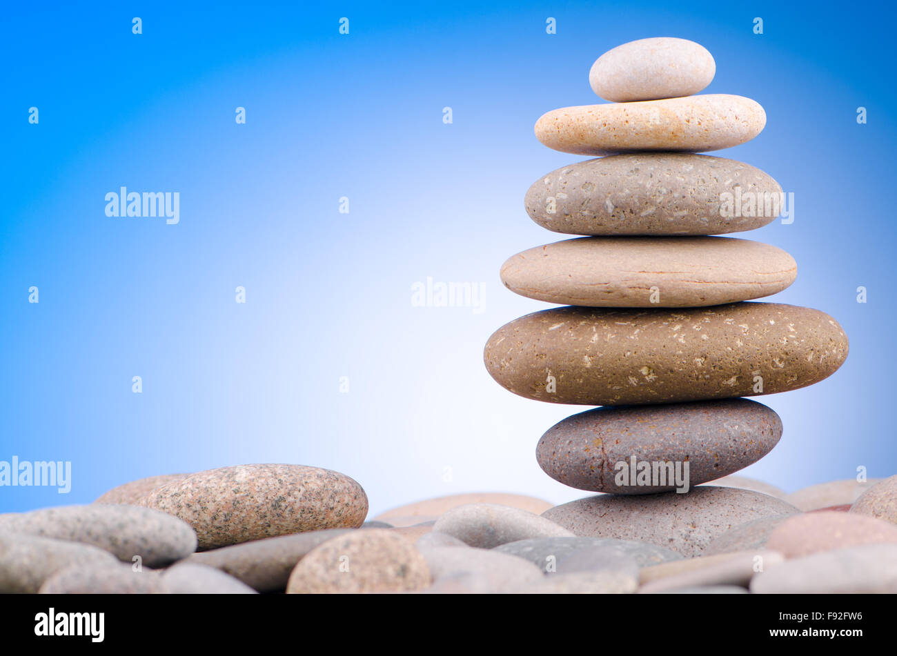 Pebbles stack against gradient background Stock Photo - Alamy