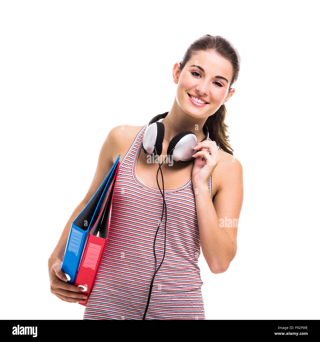 Beautiful young student with books and headphones, isolated over a ...
