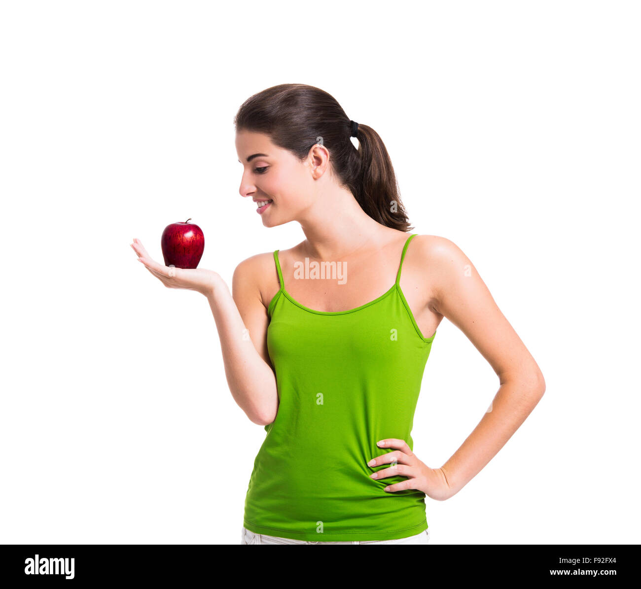 Healthy woman eating a fresh apple, isolated over a white background ...