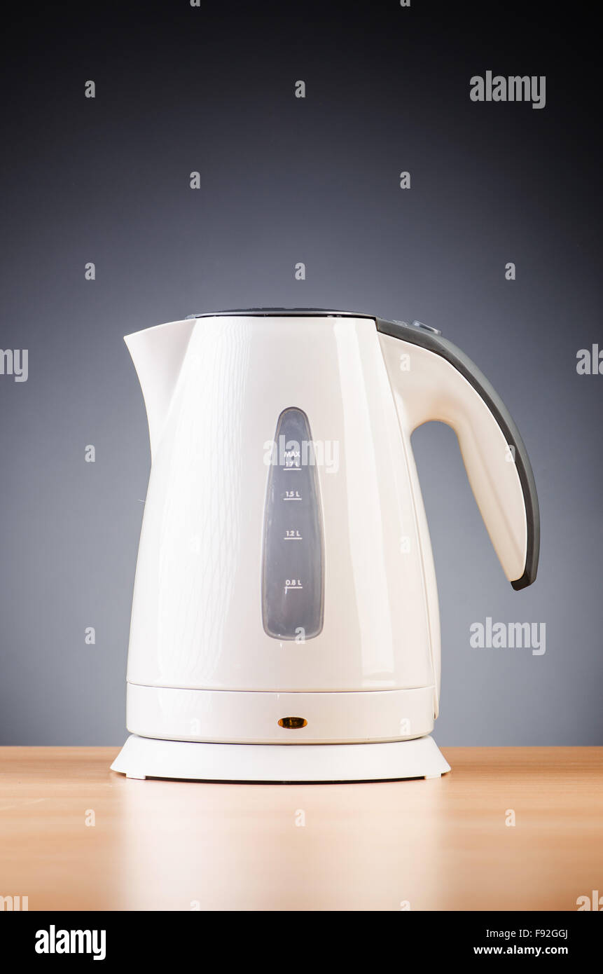 White kettle against grey background Stock Photo - Alamy