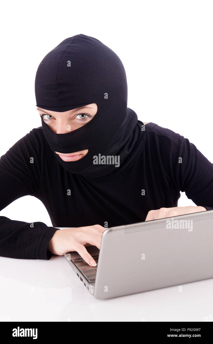 Hacker with computer wearing balaclava Stock Photo - Alamy